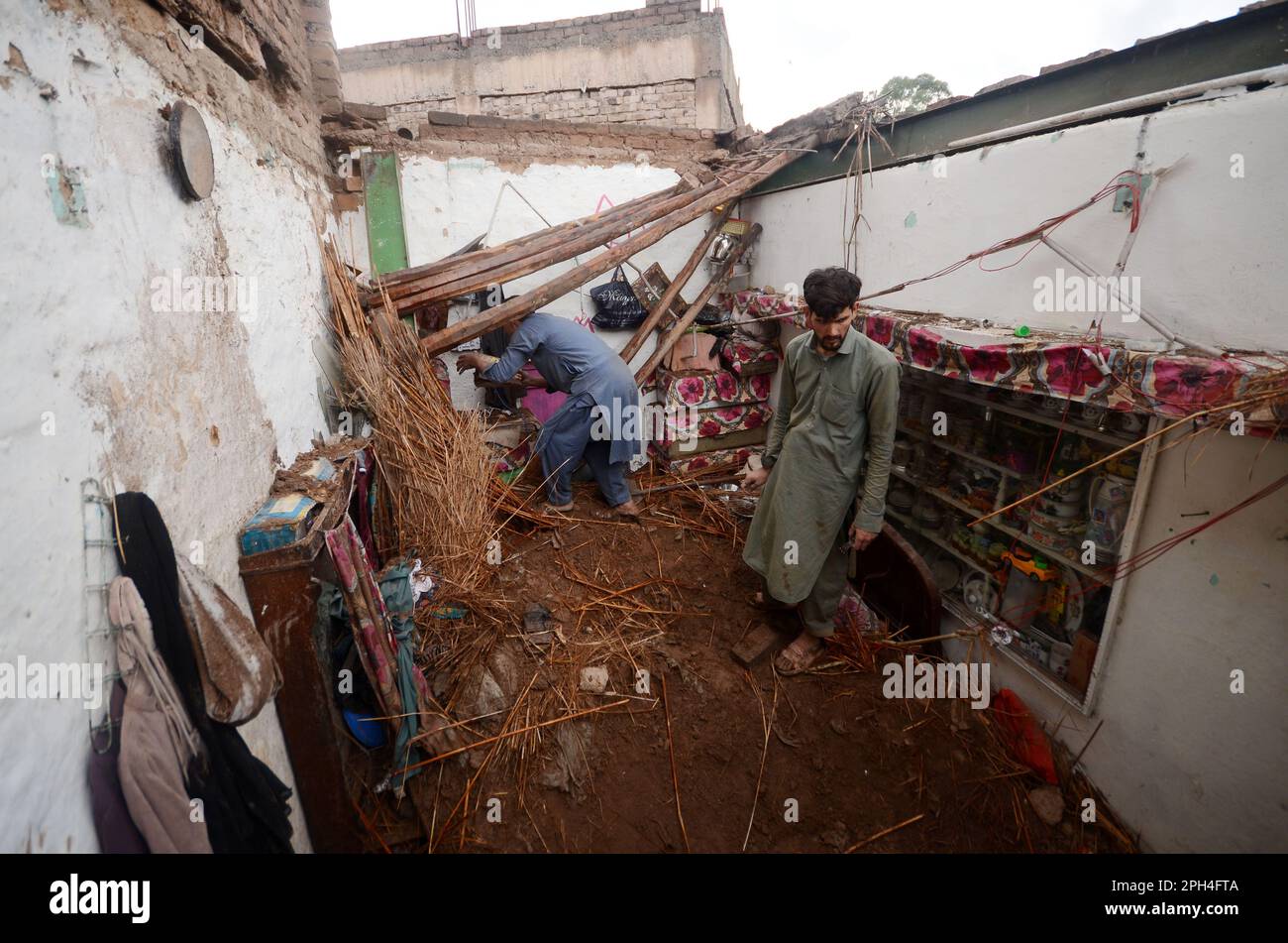 Peshawar, Pakistan. 25th Mar, 2023. People inspect the damaged room ...