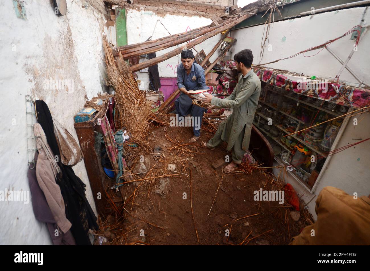 Peshawar, Pakistan. 25th Mar, 2023. People inspect the damaged room ...