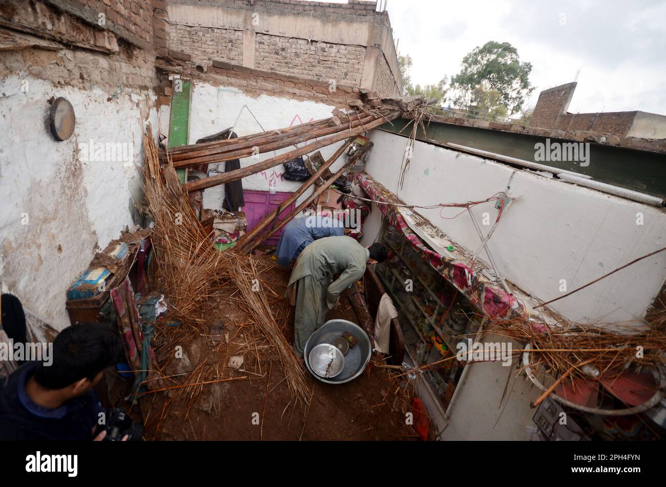 Peshawar, Pakistan. 25th Mar, 2023. People inspect the damaged room ...