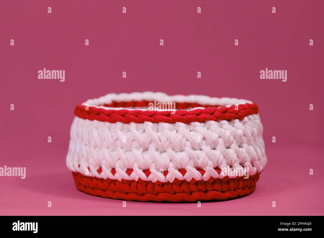 Crochet Home Basket on pink background. Front view. Red and white round ...