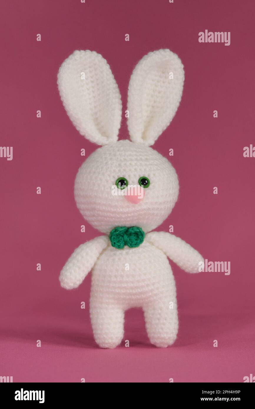 Concept symbol of Catholic Easter. White Easter bunny crocheted ...
