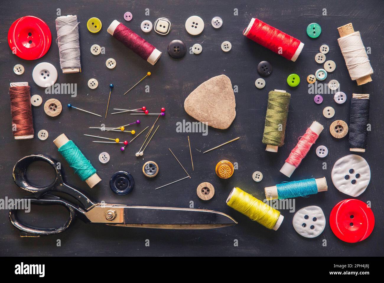 Tailor's set. Scissors, needles, threads, buttons, thimble and chalk ...