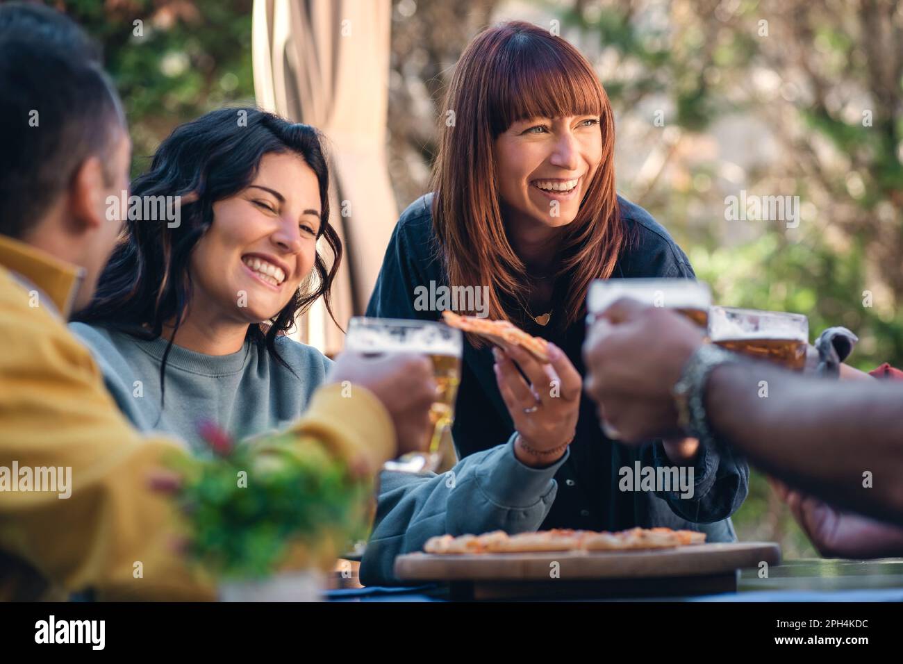 A group of young millennials friends having a good time at an outdoor ...