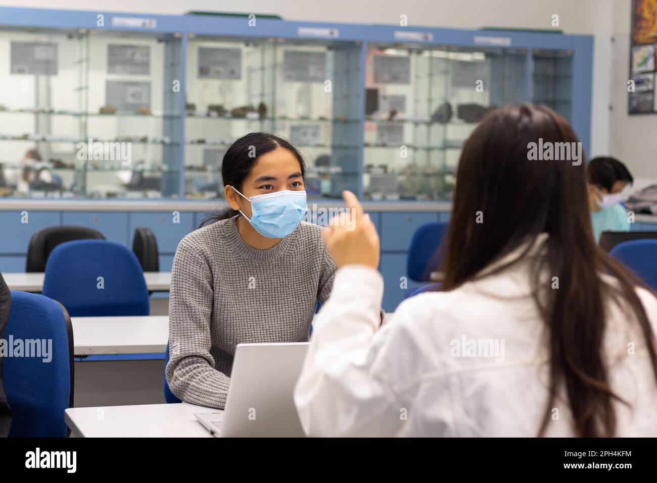 happy young boys and girls with face mask work, discuss, study on ...