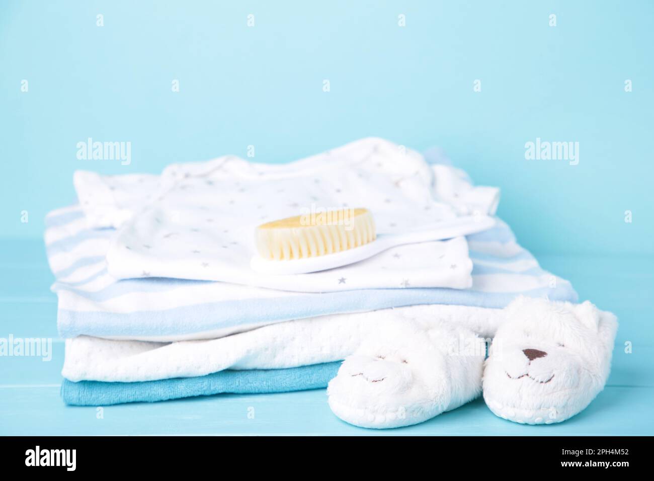 Set of children's clothes with a comb and white slippers after a shower ...
