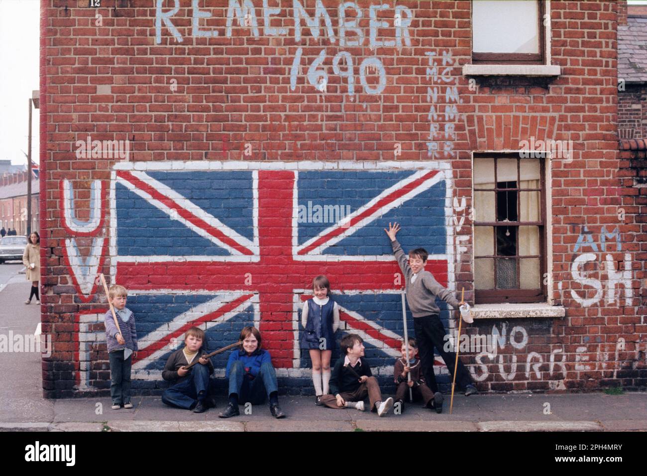 Children express loyalty to the Ulster Volunteer Force by a mural of ...