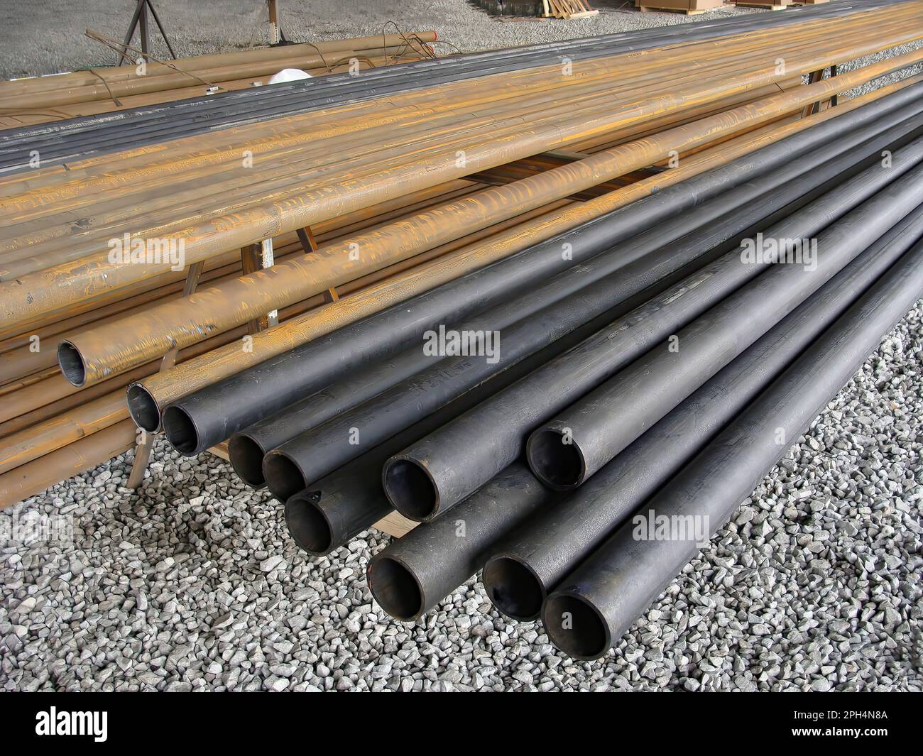 Storage of long plastic and steel pipes on the construction site ...