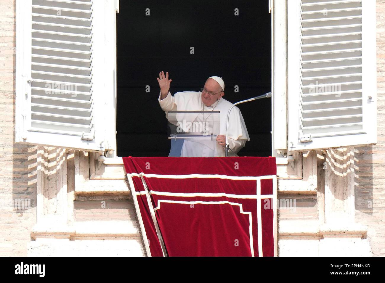 Pope Francis waves during the Angelus noon prayer from the window of ...
