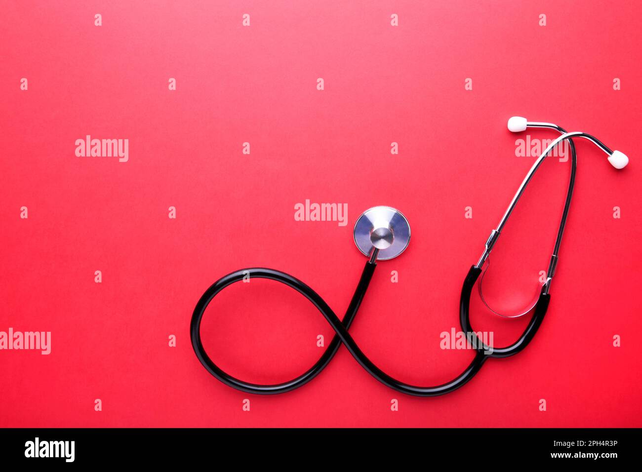 Medical stethoscope on red background with copy space Stock Photo - Alamy