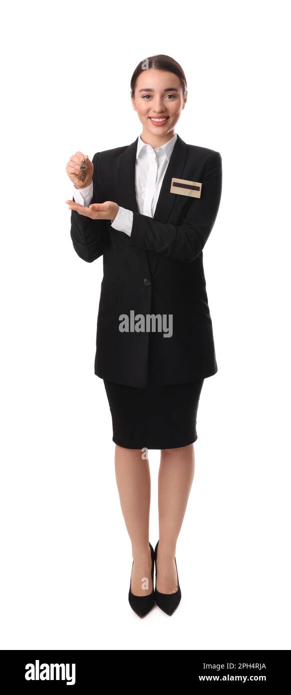 Happy young receptionist in uniform holding key on white background ...