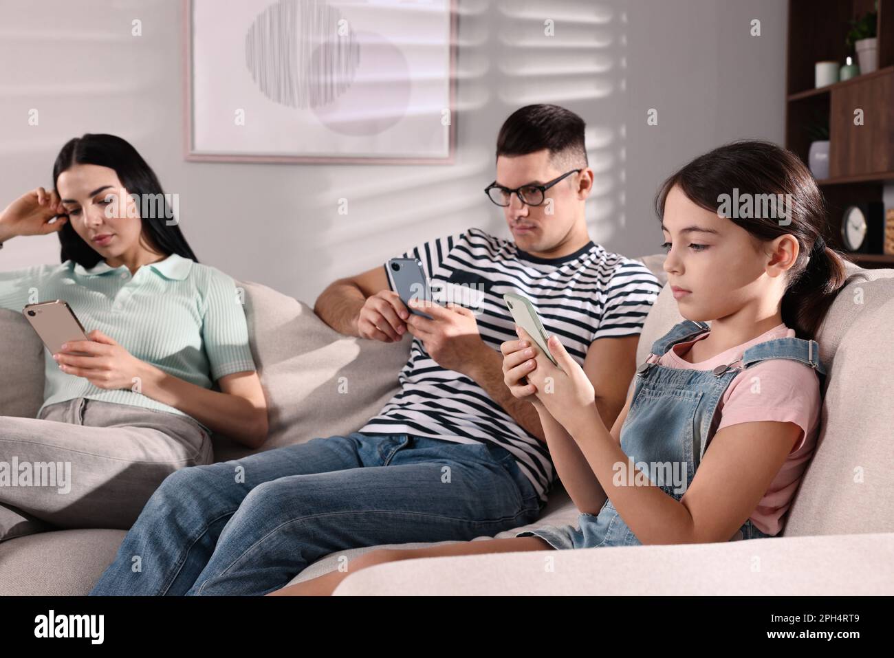 Internet addiction. Family with different gadgets on sofa at home Stock ...