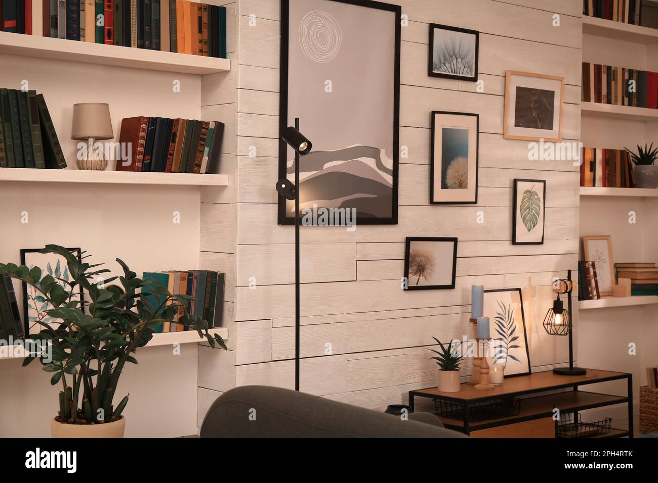 Home library interior with collection of different books on shelves and ...
