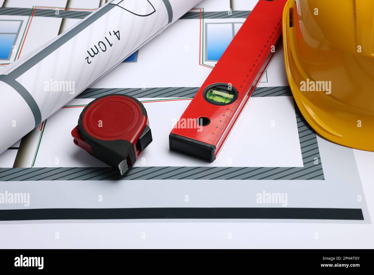 Construction drawing, safety hat, tape measure and bubble level on ...