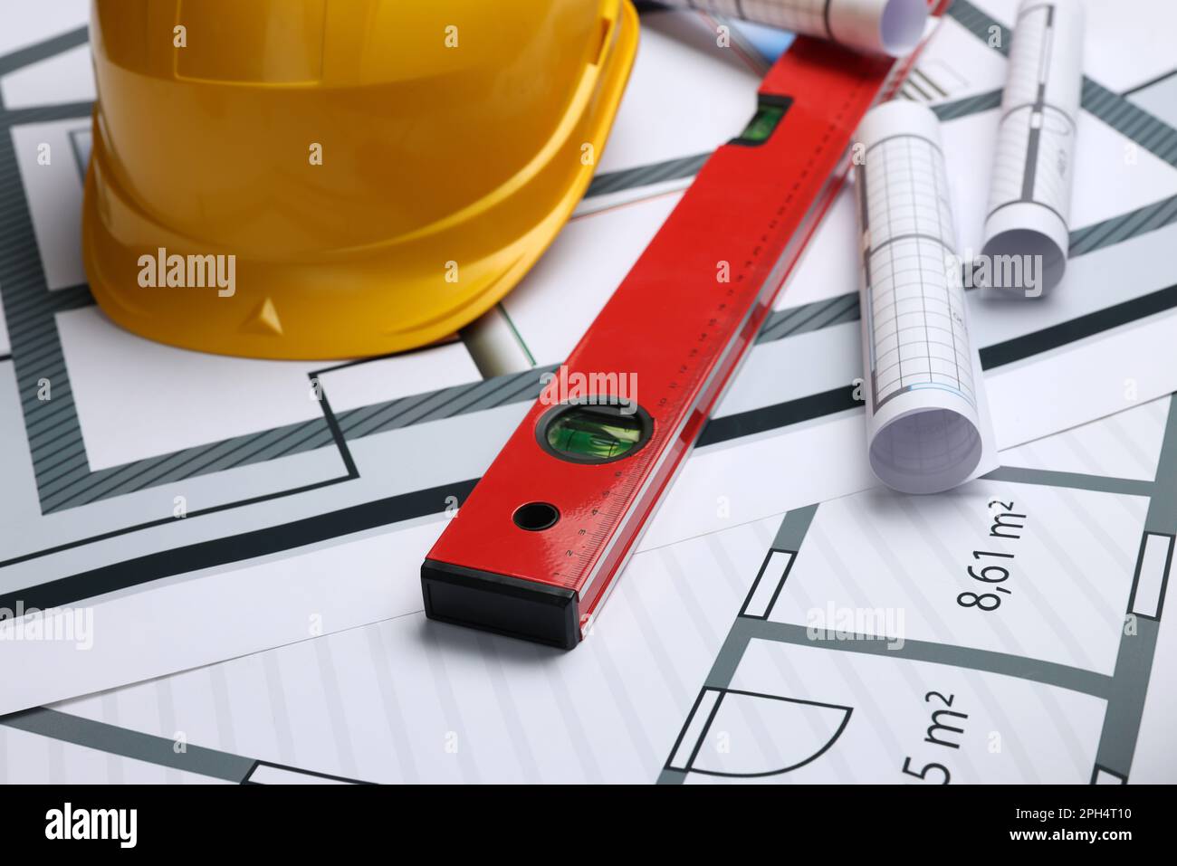 Construction drawings, safety hat and bubble level on house plan ...