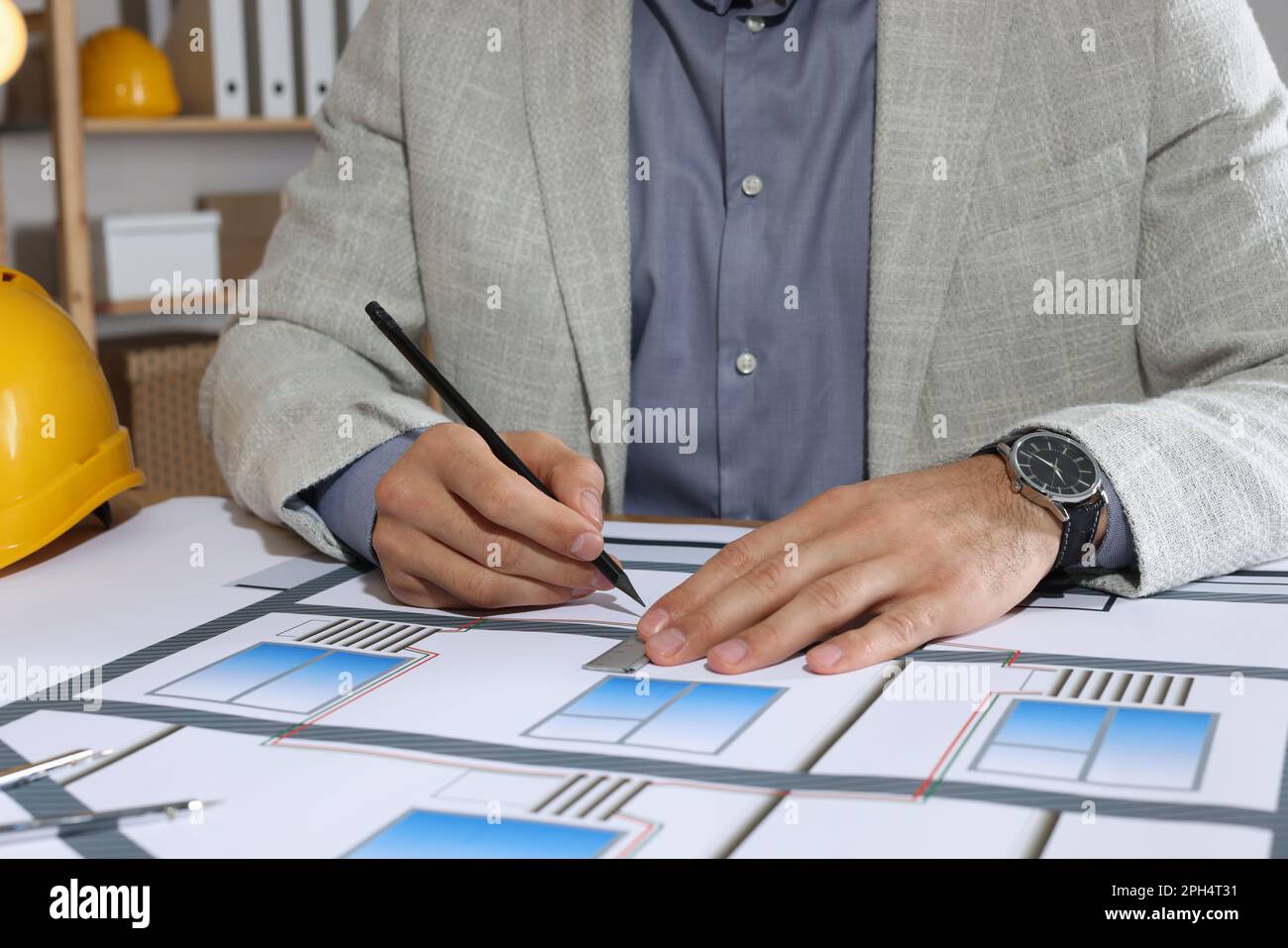 Architect working with construction drawings in office, closeup Stock ...