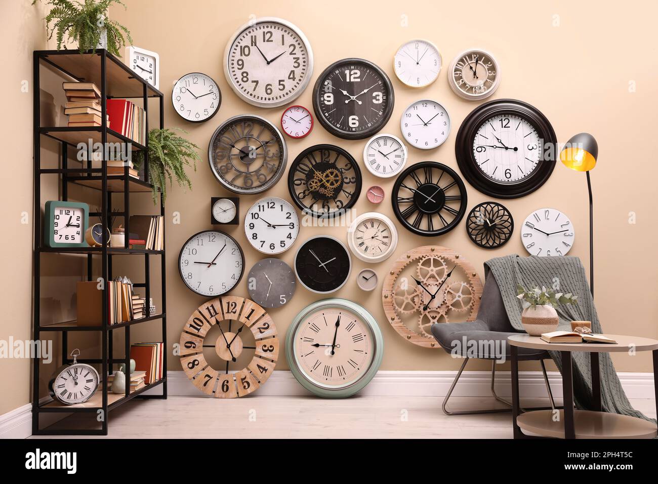 Stylish room interior with collection of wall clocks Stock Photo - Alamy