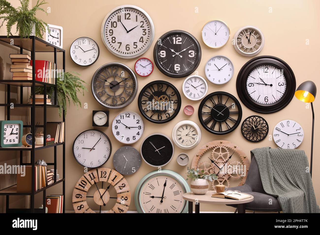 Stylish room interior with collection of wall clocks Stock Photo - Alamy