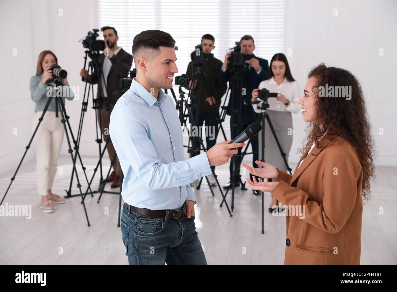 Professional journalist interviewing young African American woman ...