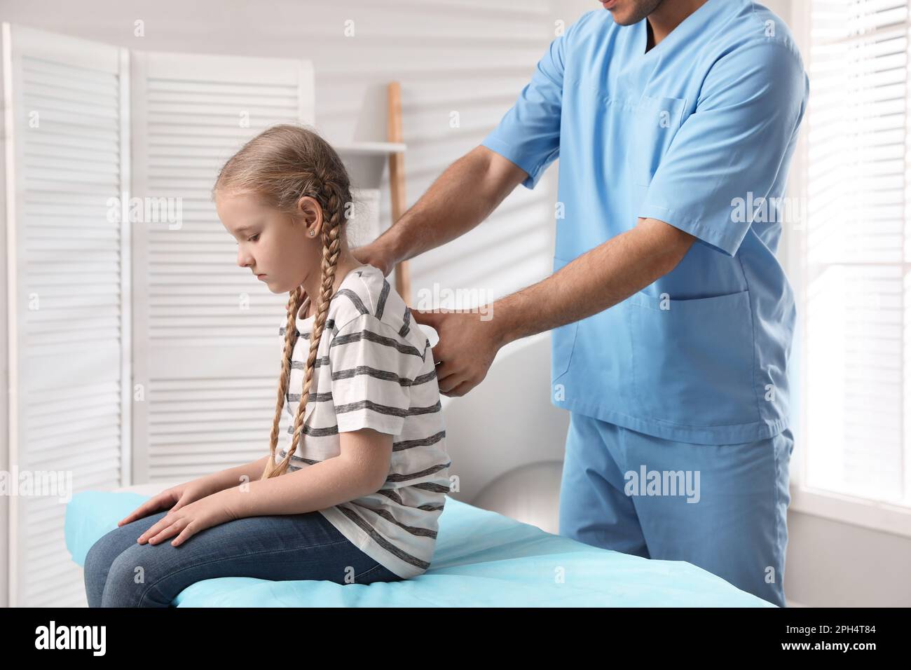 Orthopedist examining child's back in clinic, closeup. Scoliosis ...