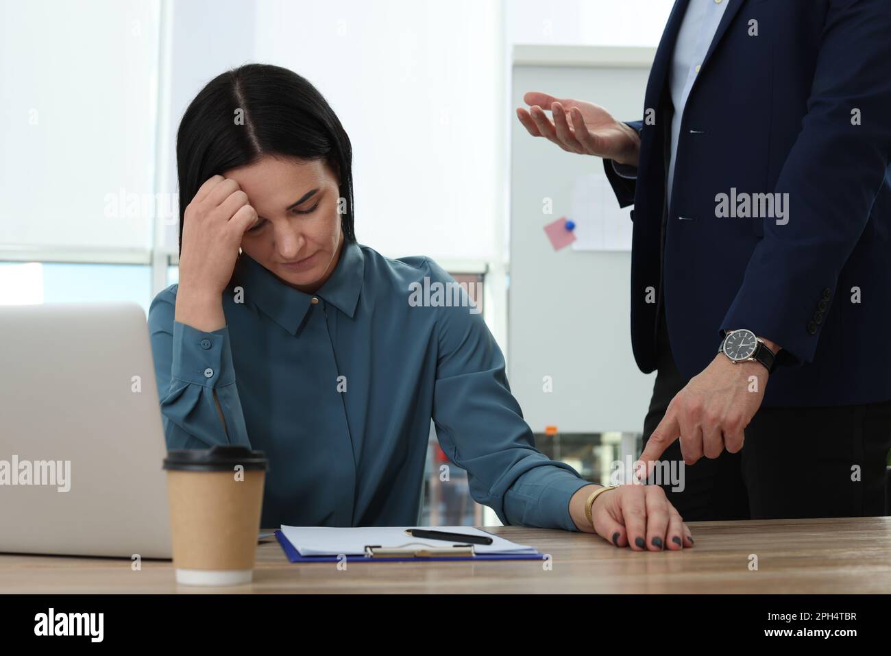 Businessman scolding employee for being late in office Stock Photo - Alamy