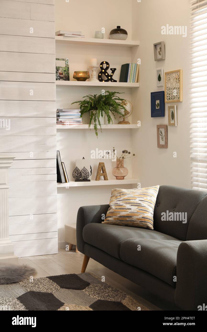 Cozy living room interior with comfortable sofa near window Stock Photo ...