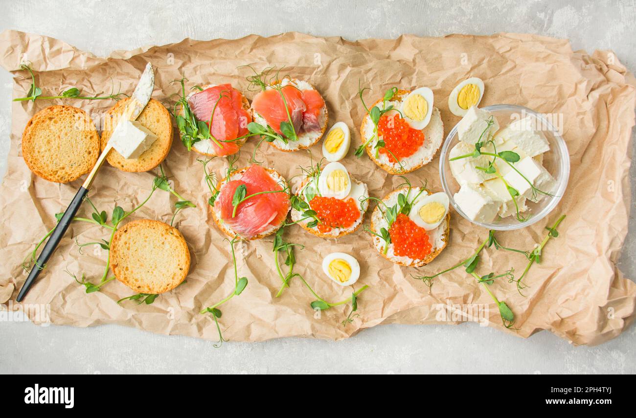 Canapes with red caviar and canapes with red fish are decorated with ...