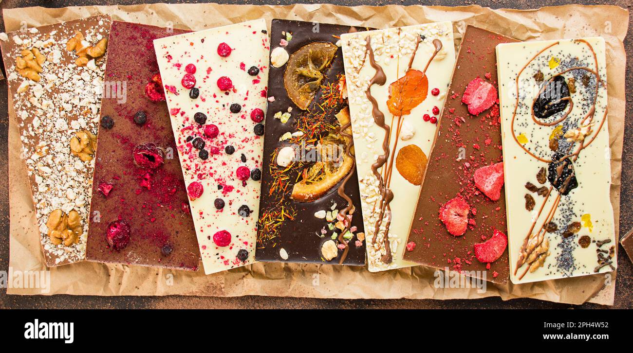 Handmade chocolate with berries, nuts, dried fruits on crumpled paper ...