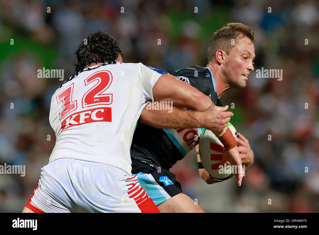 Matt Moylan of the Sharks is tackled by Jaydn Su’a of the Dragons ...
