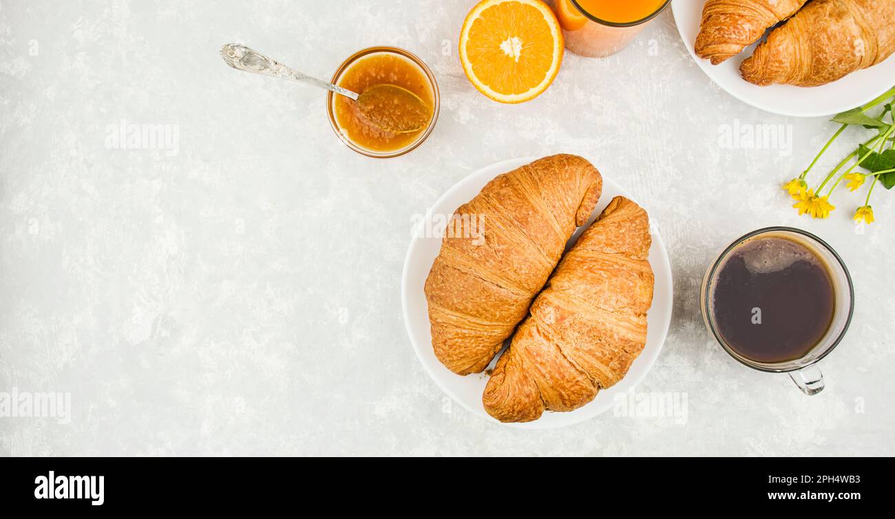 Fresh croissants with jam and coffee. European breakfast on a light ...