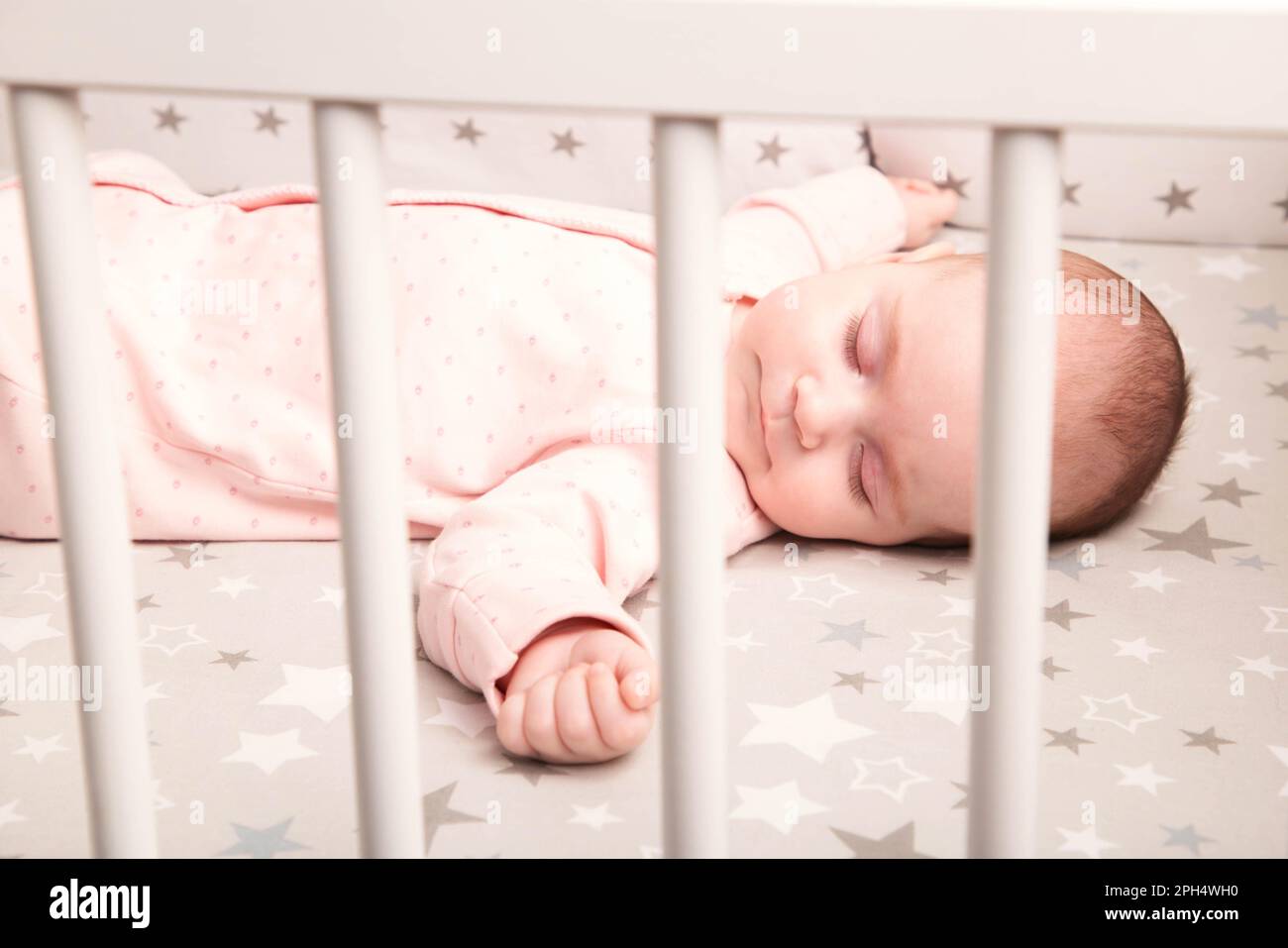Cute baby sleeping in a white crib. Top view Stock Photo - Alamy