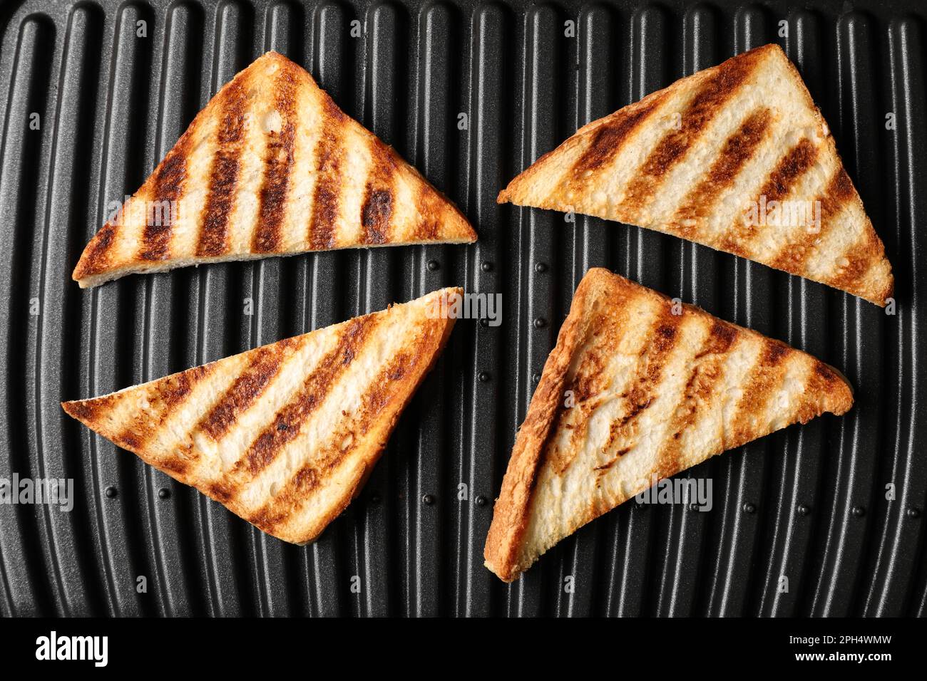 Modern sandwich maker with bread slices, top view Stock Photo - Alamy