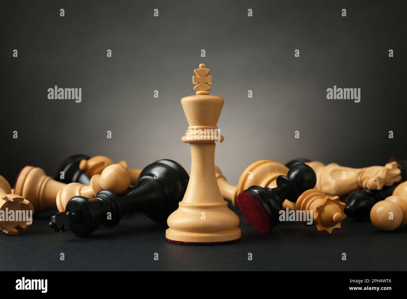 White king among fallen chess pieces on dark background Stock Photo - Alamy
