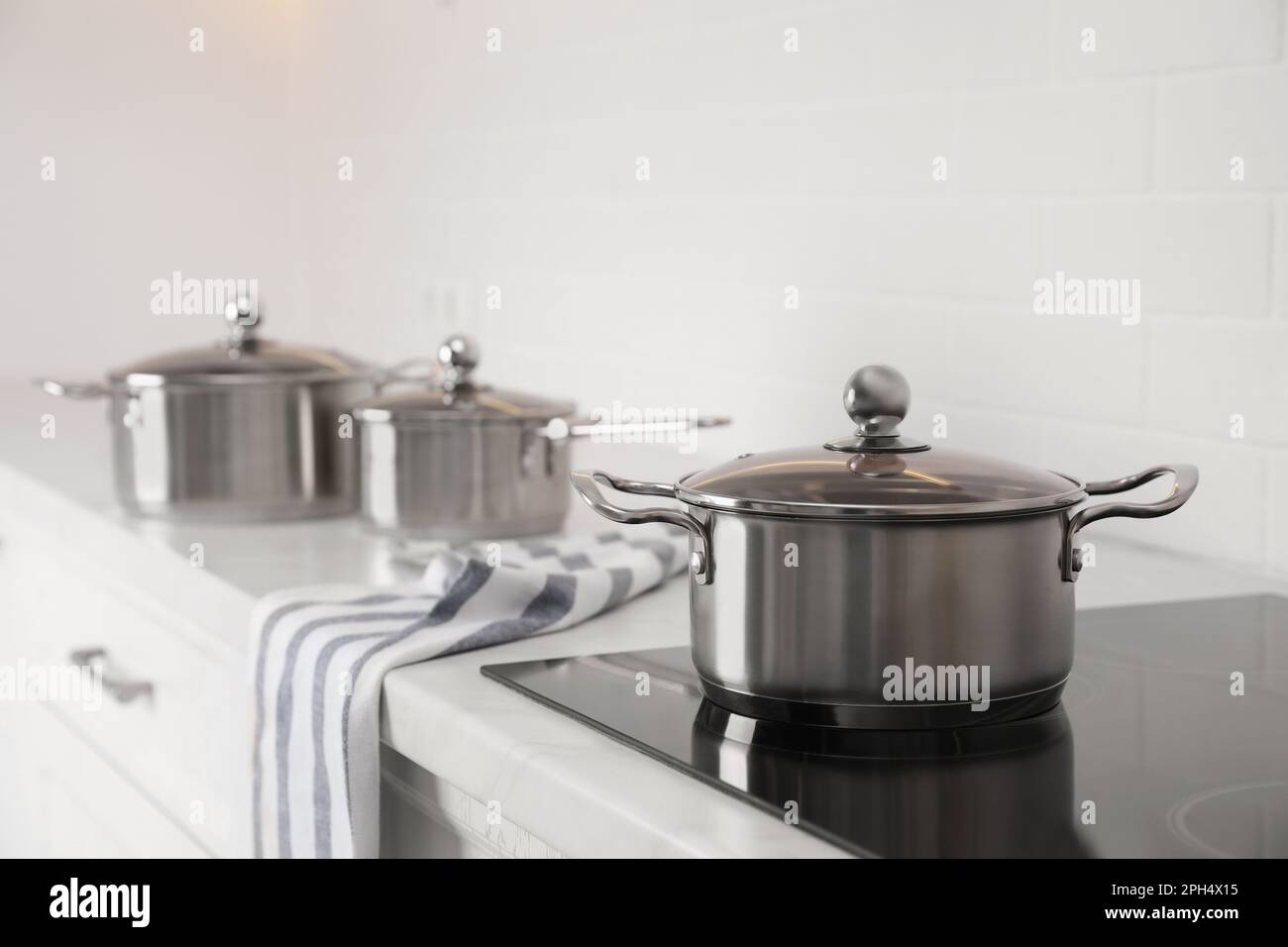 New clean pot on cooktop in kitchen, space for text Stock Photo - Alamy
