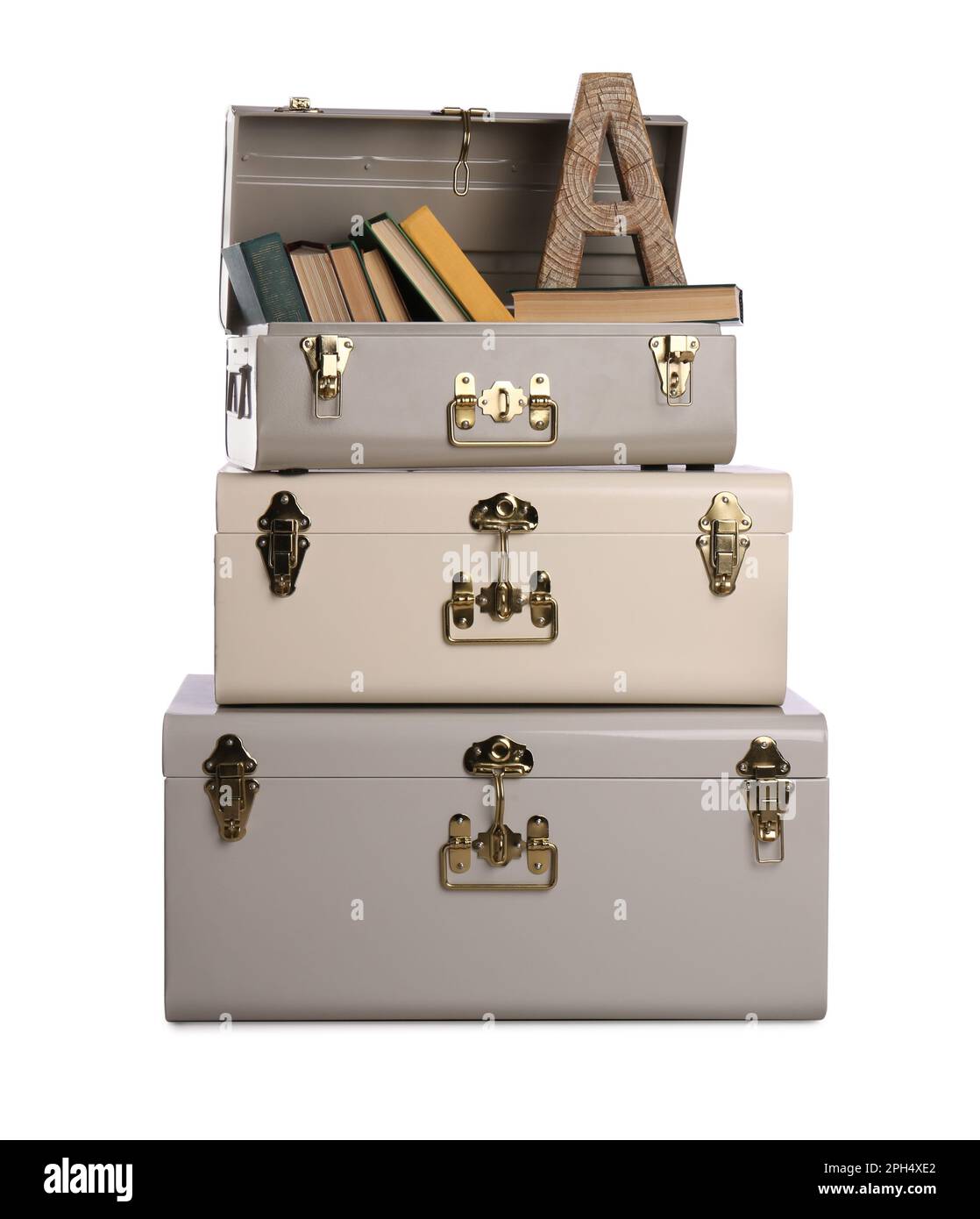 Stylish storage trunks with books and wooden letter A isolated on white ...