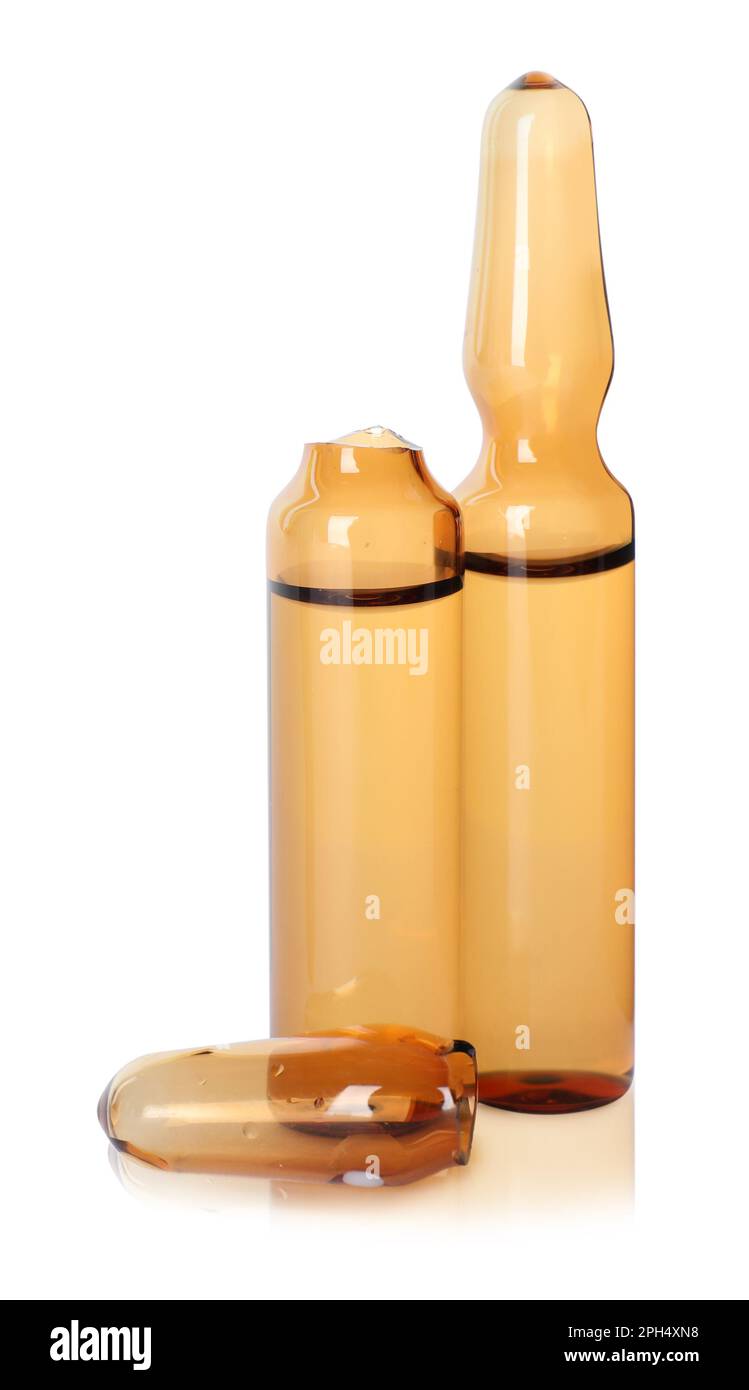 Open and closed glass ampoules with pharmaceutical product on white ...