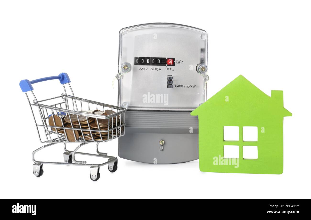 Electricity meter, house model and small shopping cart with coins on ...