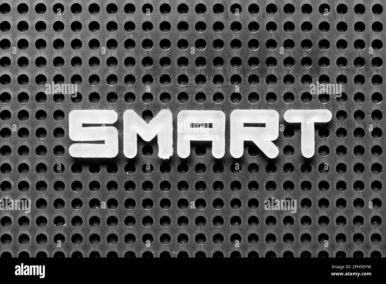 White alphabet letter in word smart on black pegboard background Stock ...