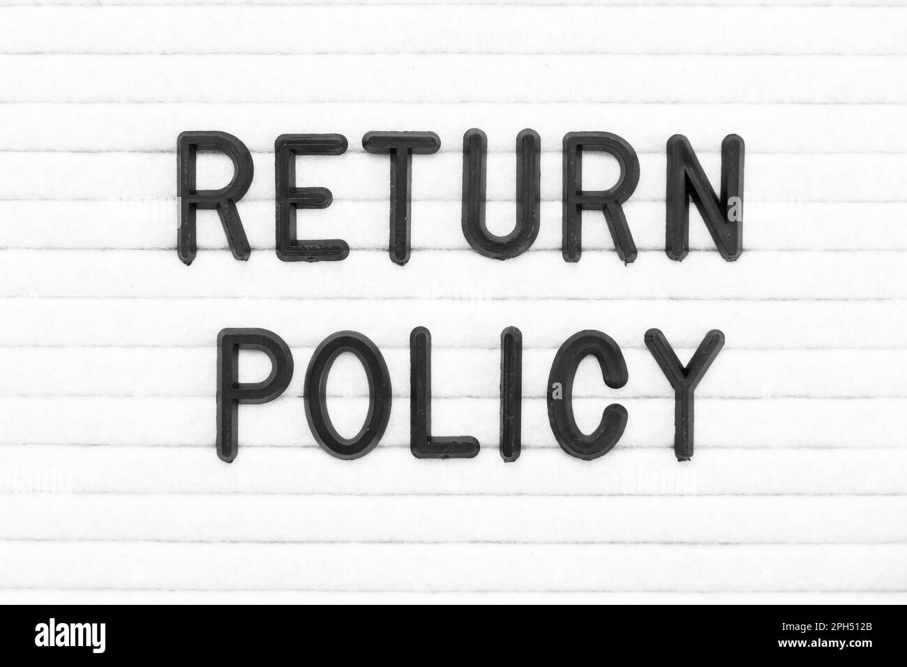 Black color letter in word return policy on white felt board background ...