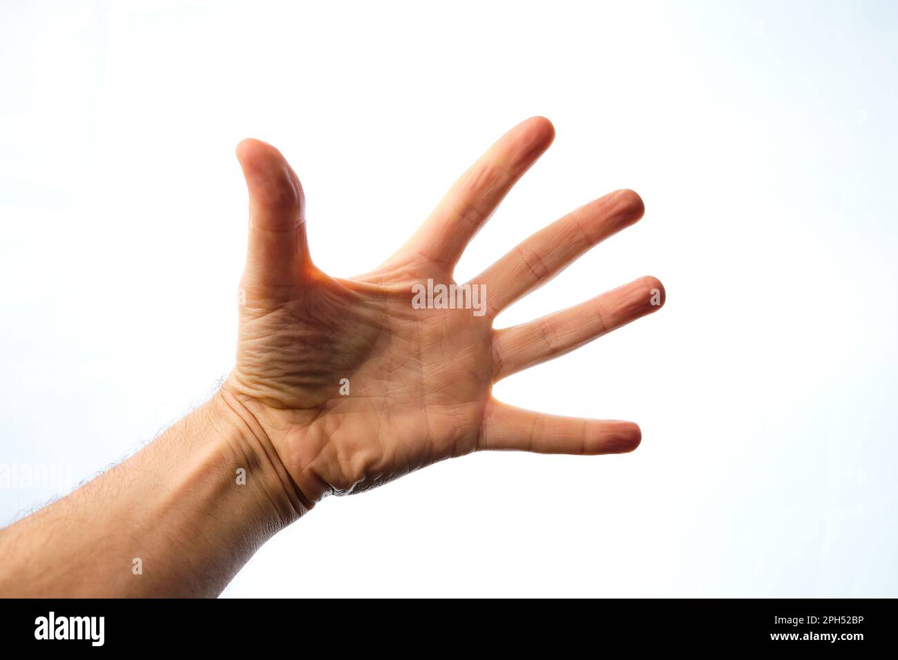 Man's open hand with five fingers stretched out, with a white ...