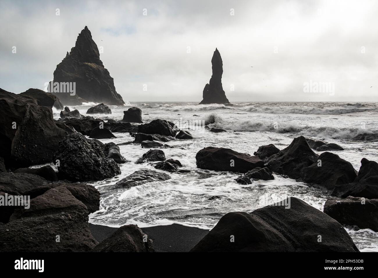 Sea water flowing among the black basalt rocks of Reynisfjara beach ...