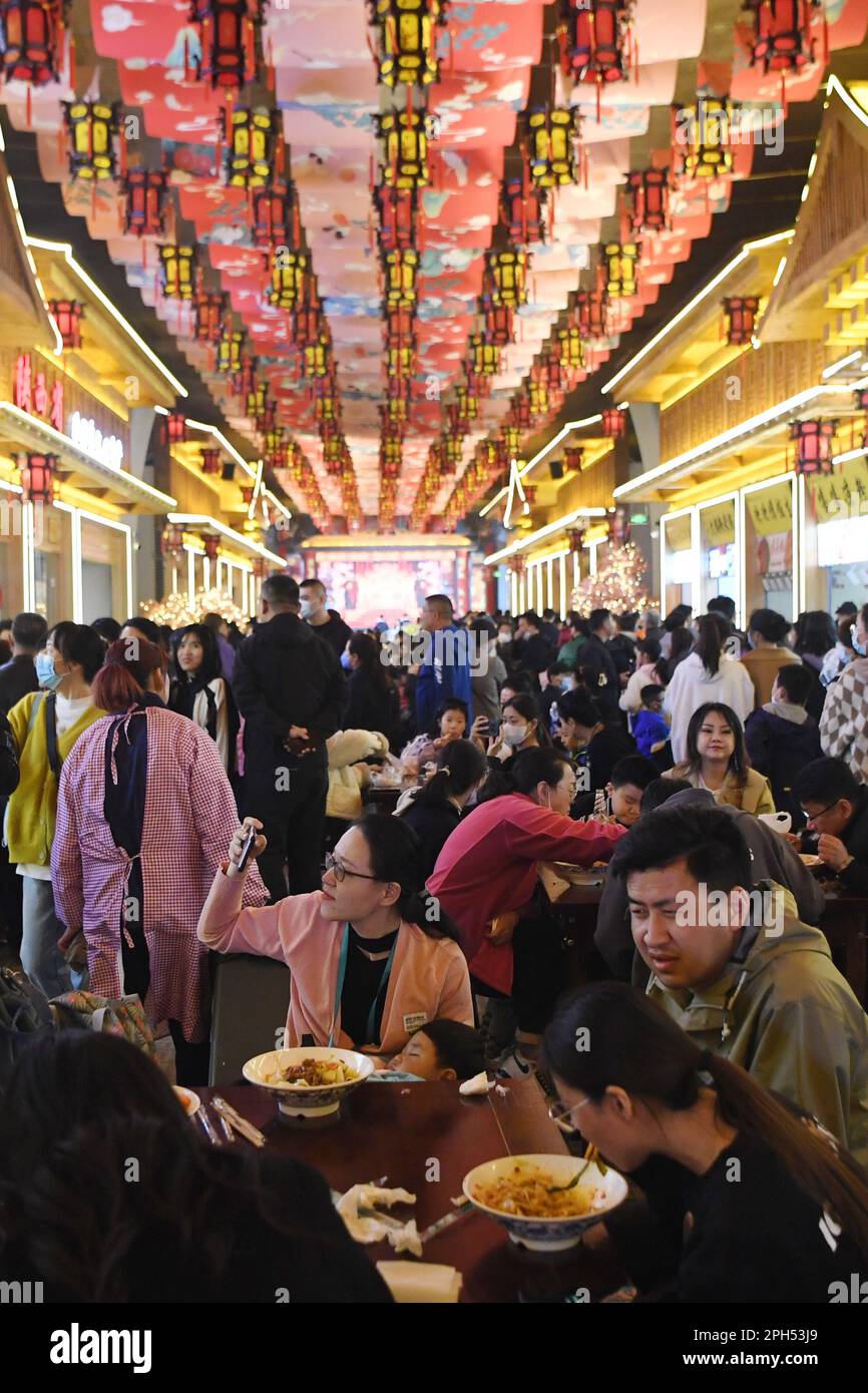 Lanzhou, China's Gansu Province. 25th Mar, 2023. Visitors taste food at ...