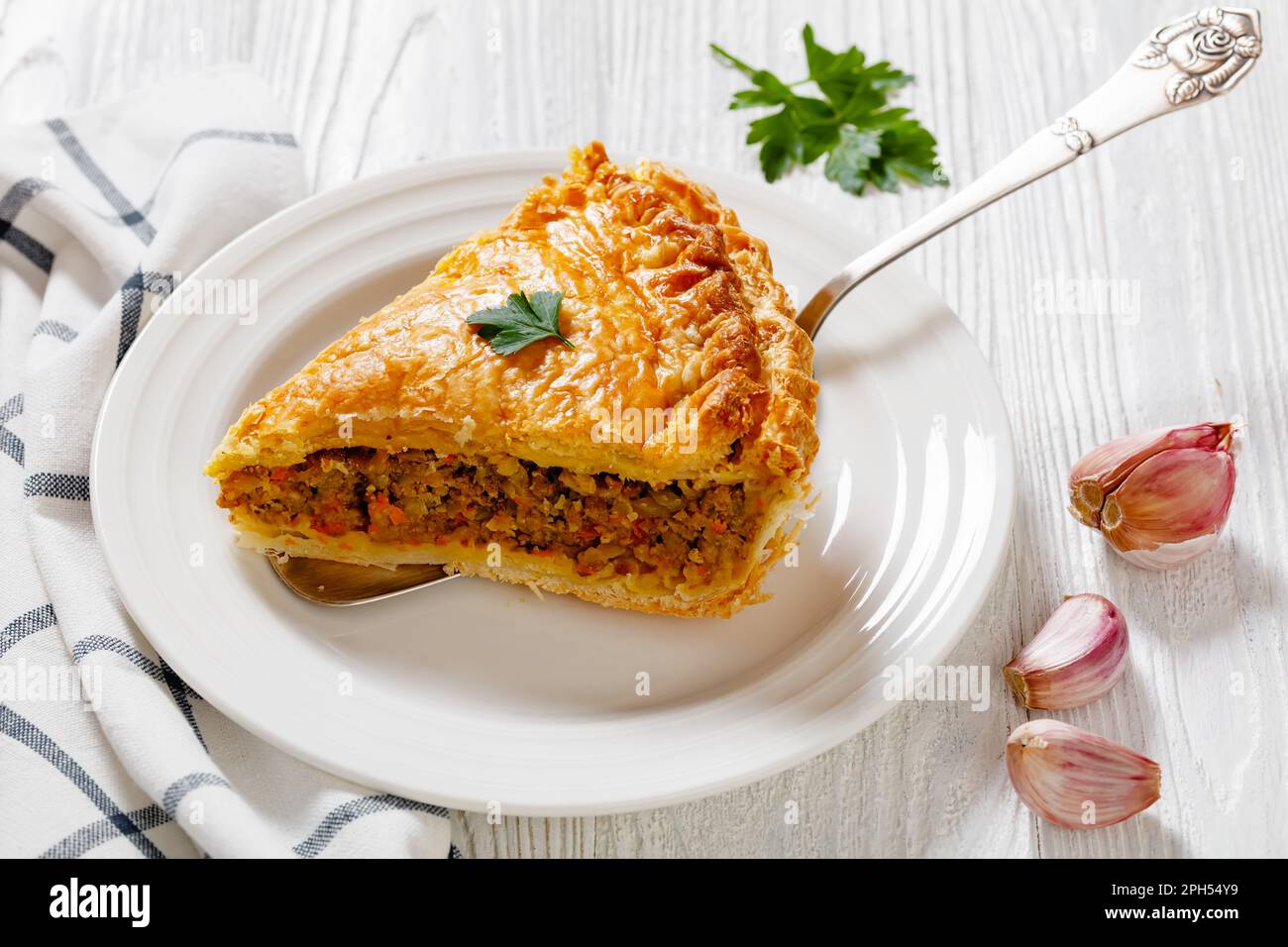 slice of Ground Beef Meat Pie with a flaky puff pastry double crust ...