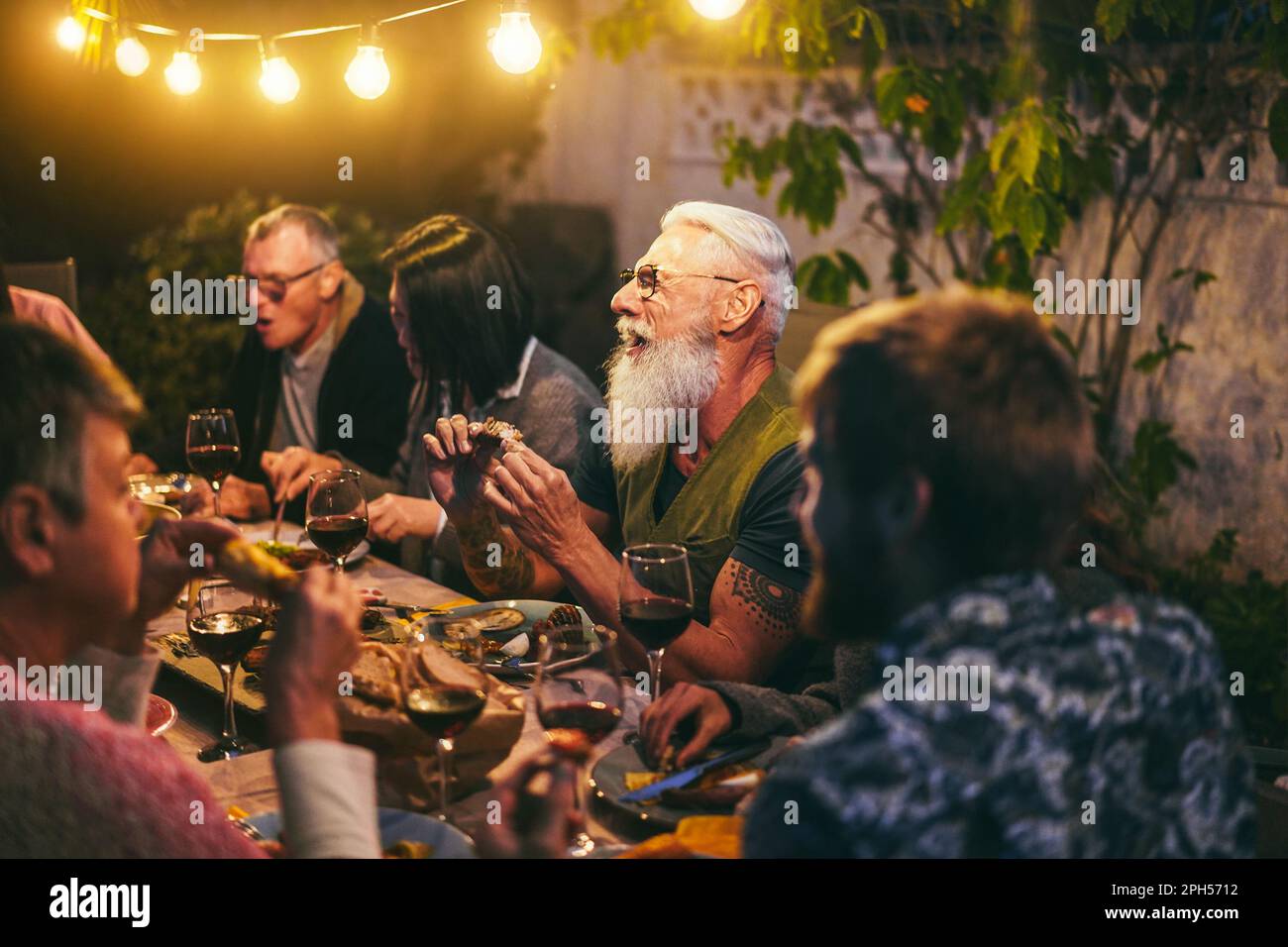 Family people eating at barbecue dinner at patio terrace - Soft focus ...