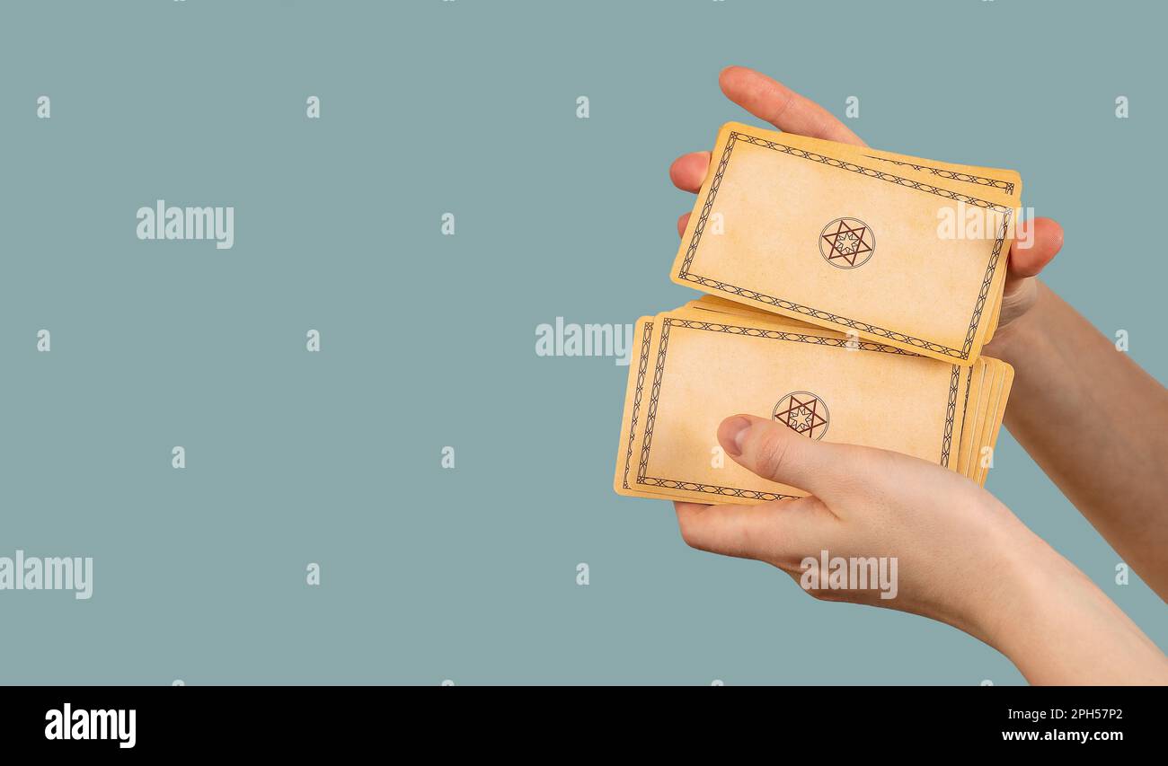 Hands shuffle, randomizing tarot cards on banner, blue background Stock ...