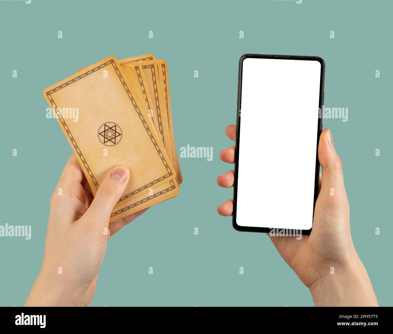 Hands holding tarot cards deck and mobile phone with blank screen ...