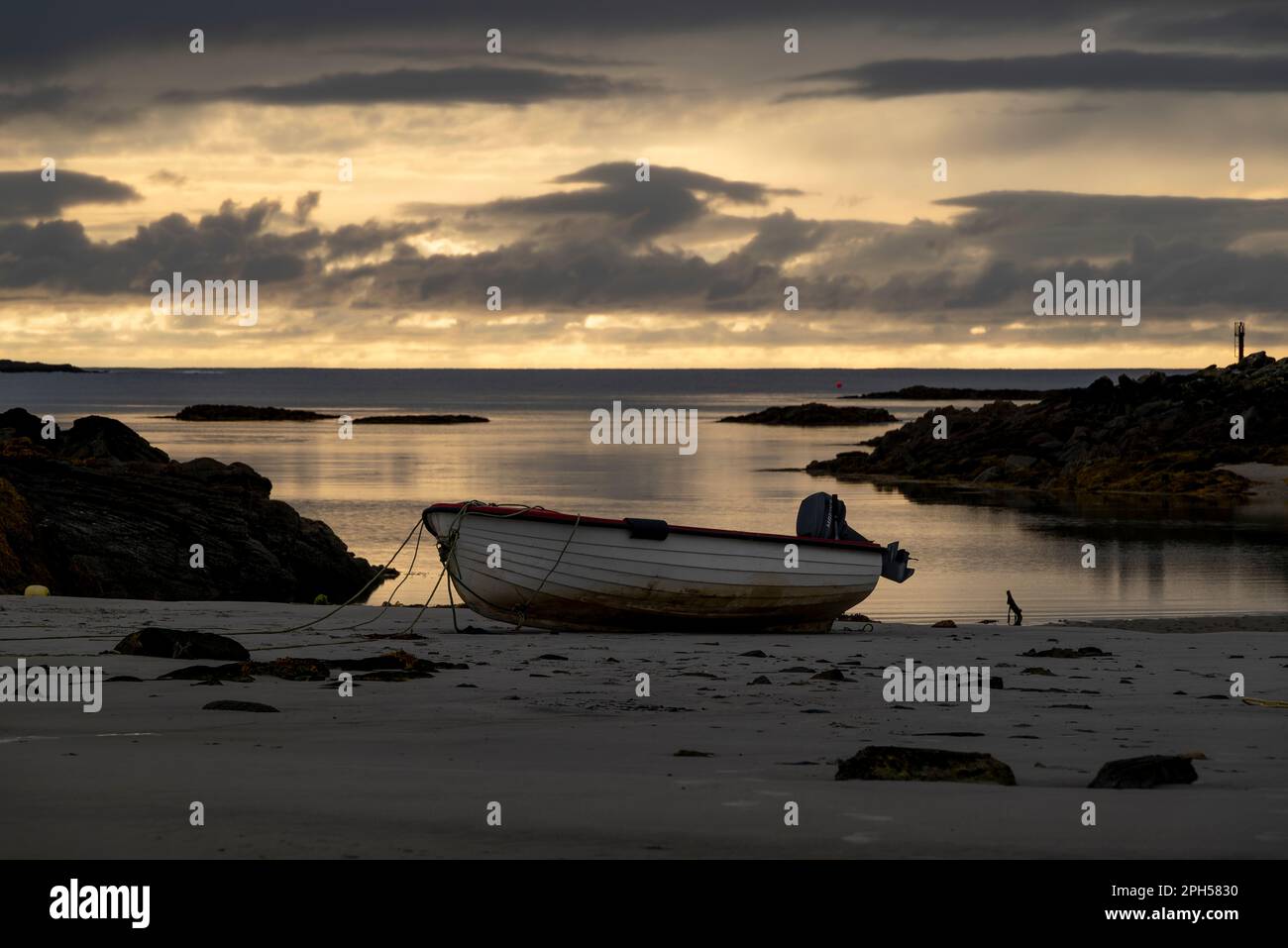 Small boat lying on the beach of Narin/Portnoo at sunset, County ...