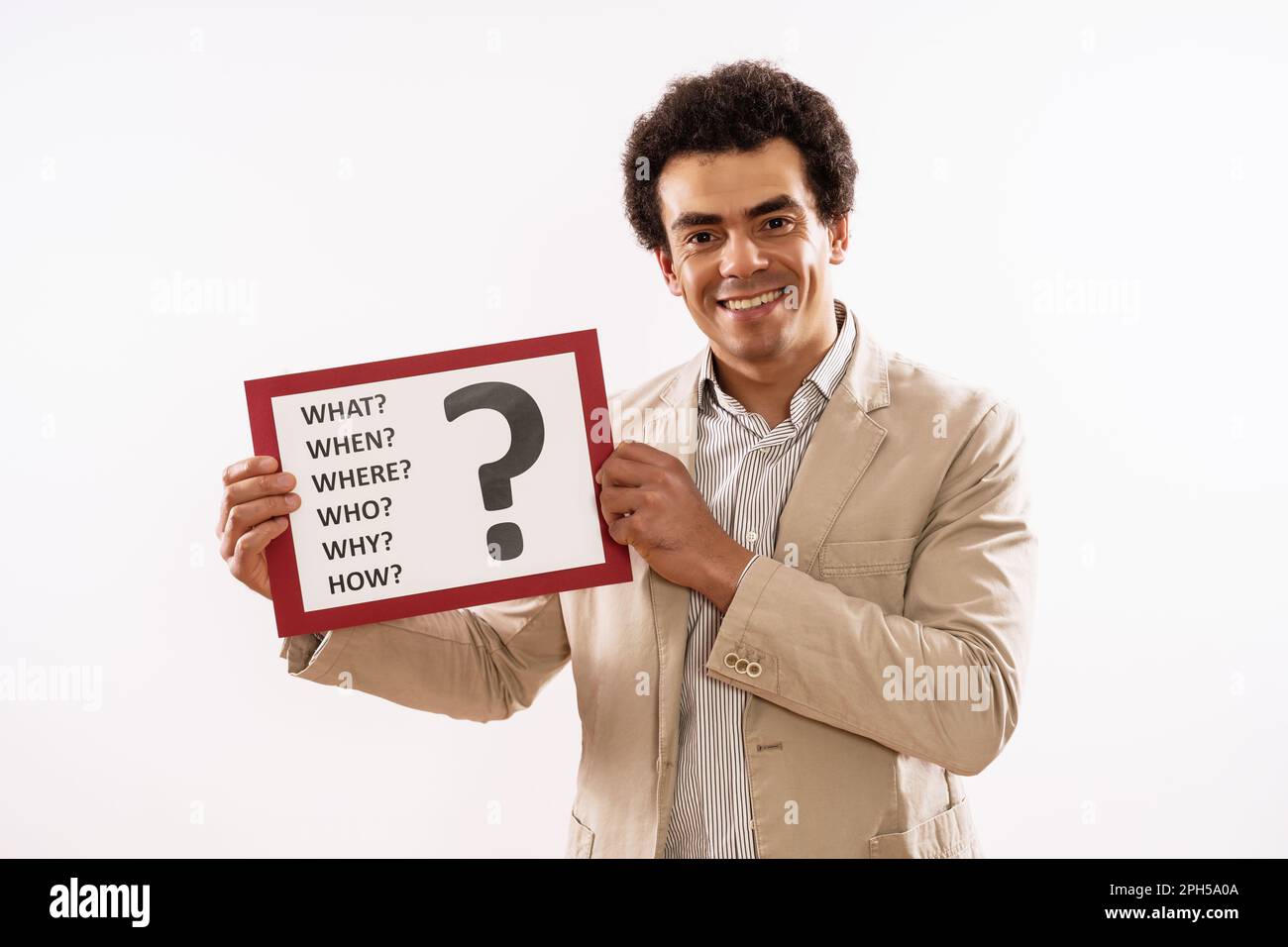 Image of businessman holding paper with question mark and various ...