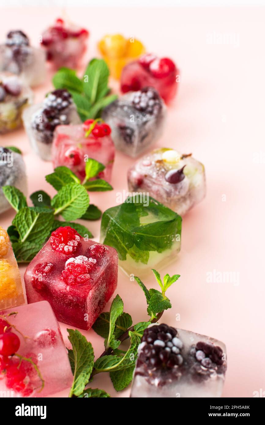 Frozen ice cubes with various berries, blackberries and raspberries ...