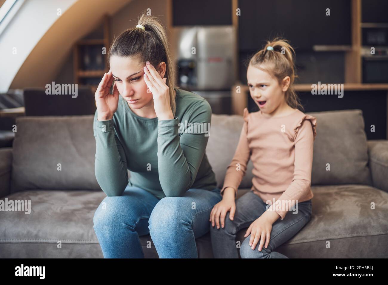 Stressed mother is feeling desperate because of screaming her daughter ...