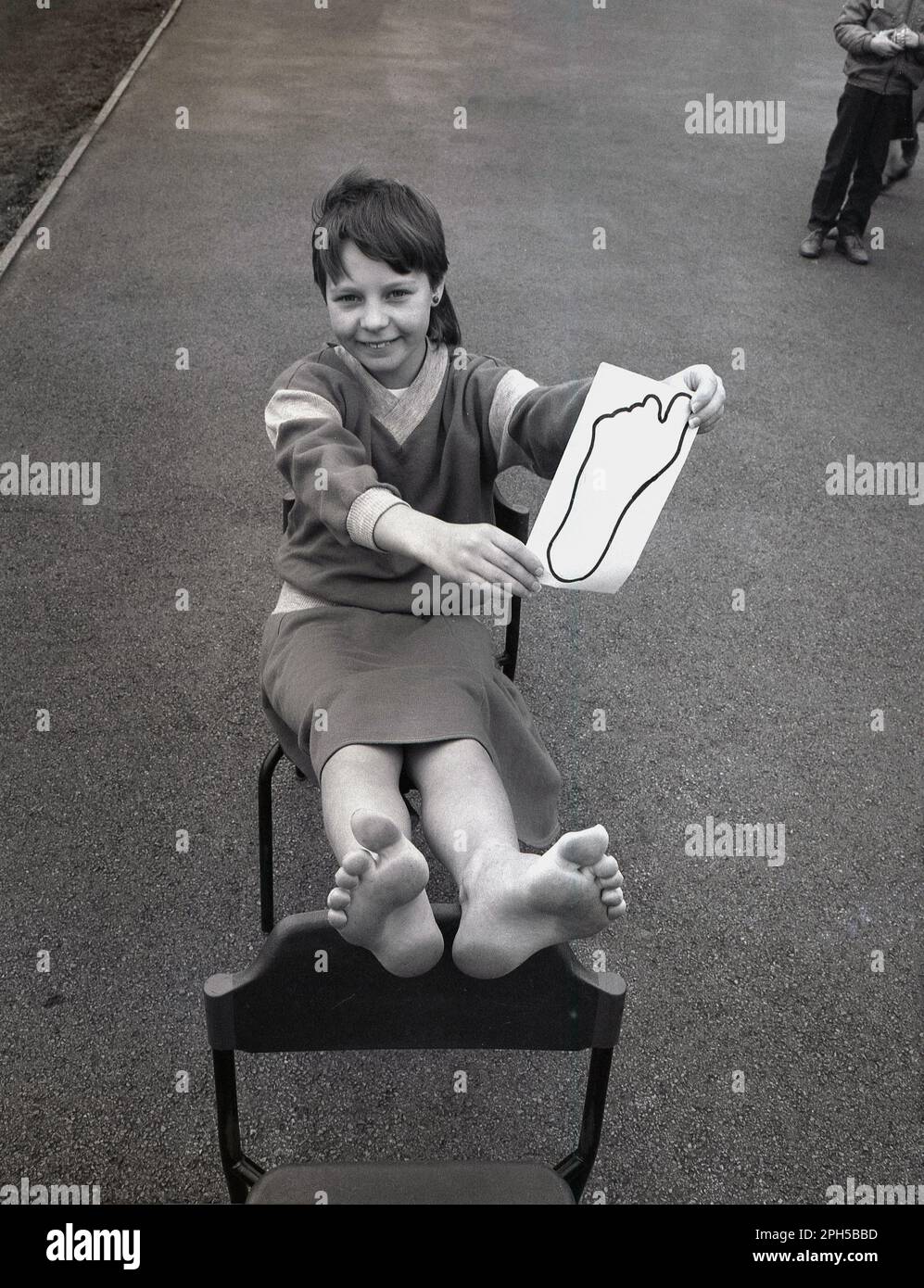 1986, a school foot drawing competition, an excited schoolgirl sitting ...